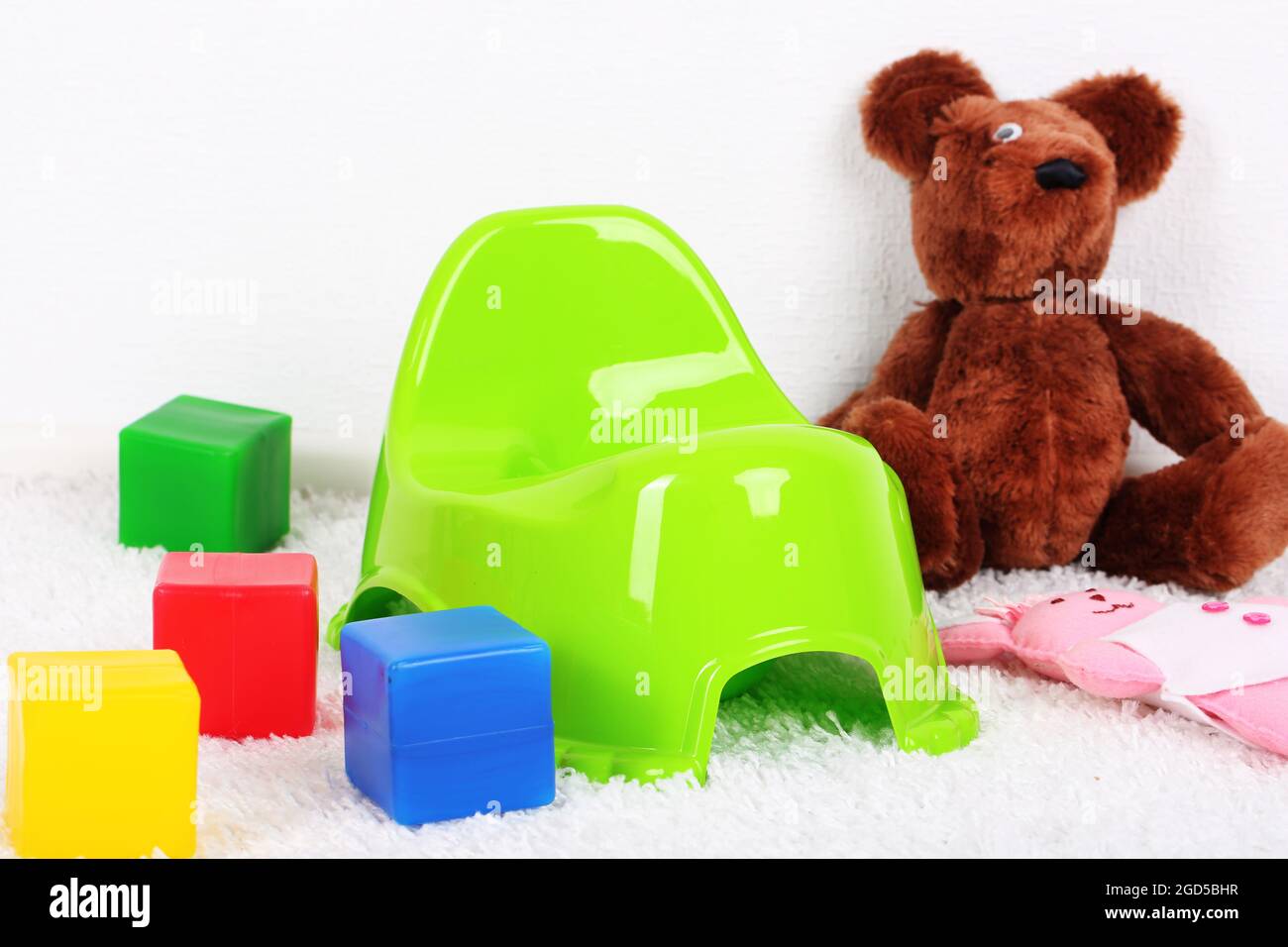 Green potty on home interior background Stock Photo - Alamy