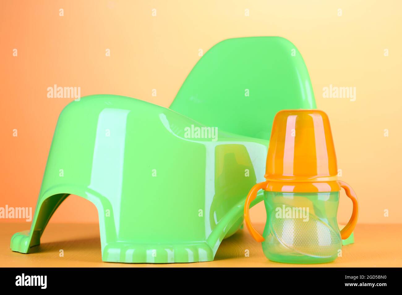 Green potty on color background Stock Photo - Alamy