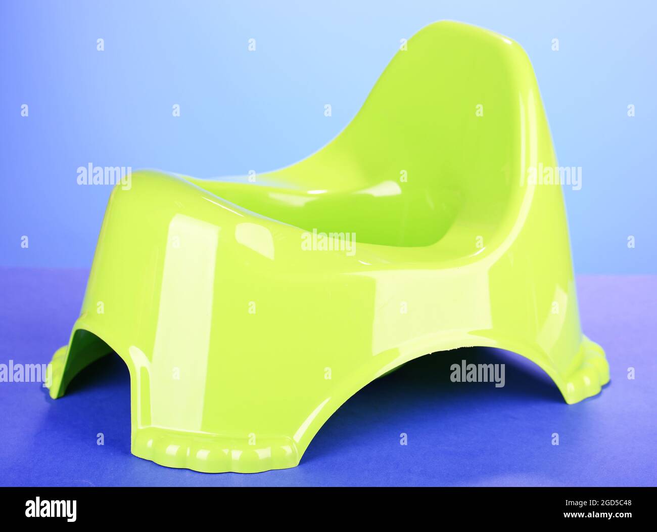 Green potty on color background Stock Photo - Alamy