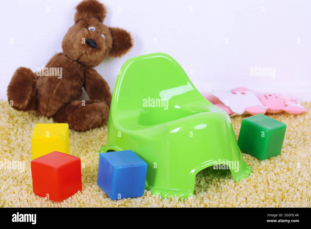 Green potty on home interior background Stock Photo - Alamy