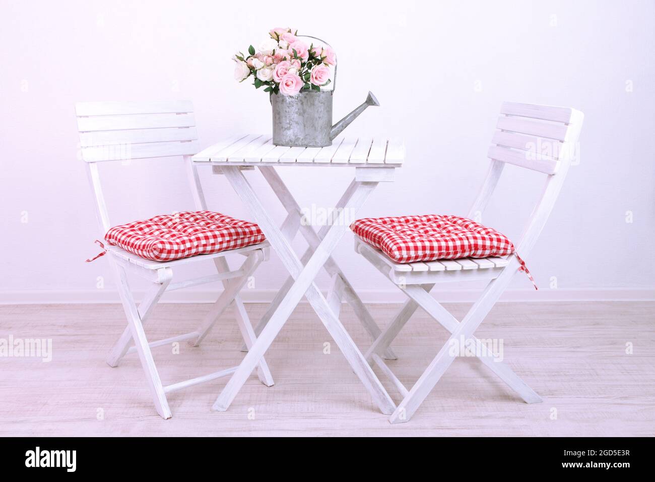 Garden chairs and table with flowers on white background Stock Photo ...