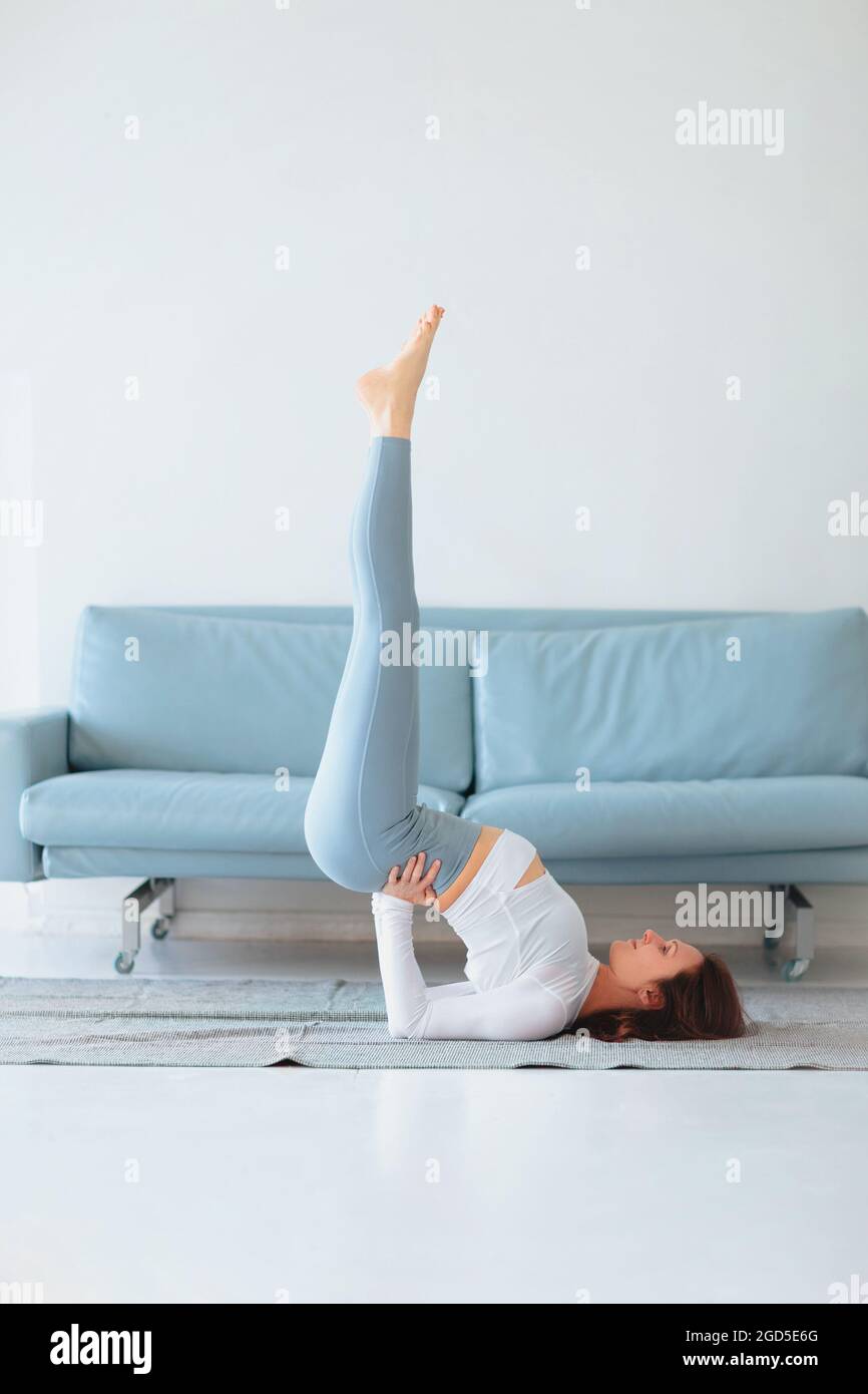Healthy living, Vertical shot of young sporty woman doing yoga in ...