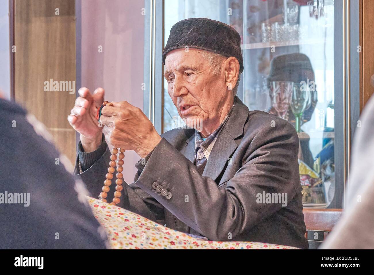 Mullah talking counting rosary at rural house Stock Photo - Alamy