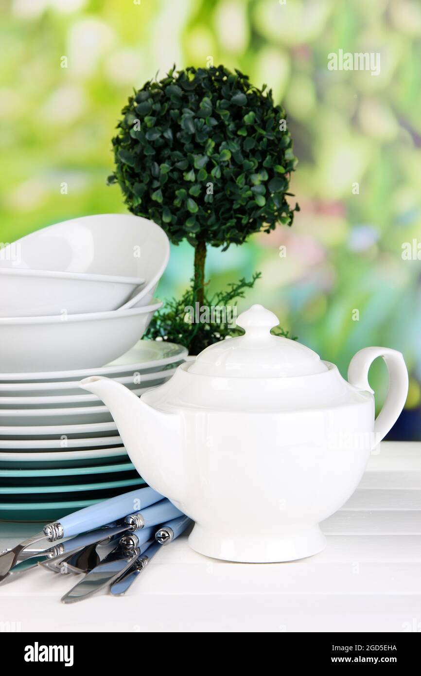 Clean dishes on table on natural background Stock Photo - Alamy