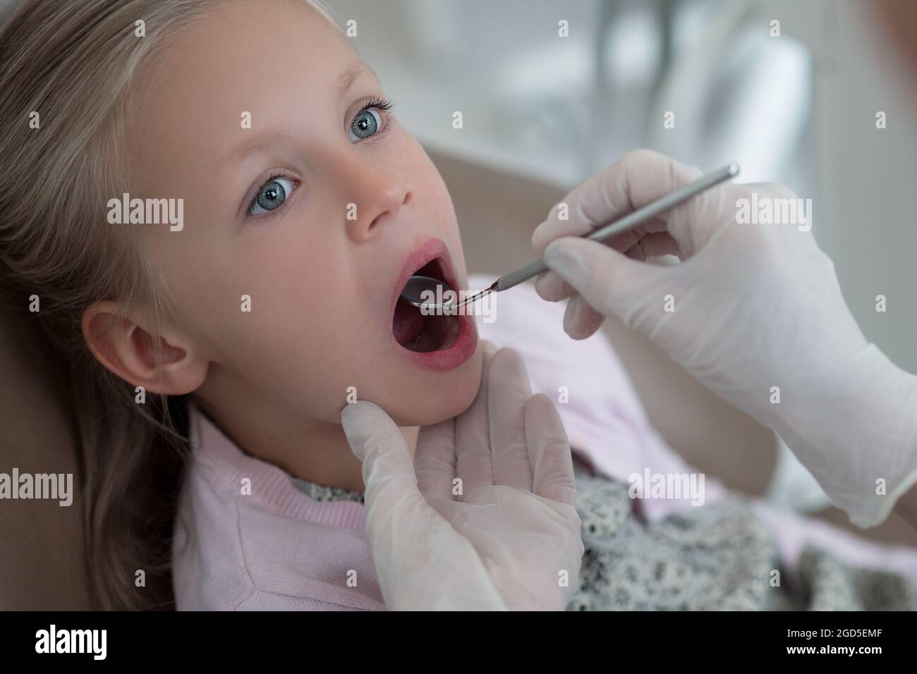 Pediadontist examining teeth of her cute small patient Stock Photo - Alamy