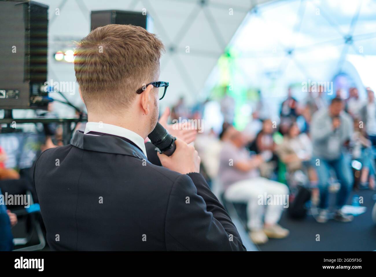 Male presenter speaks to audience Stock Photo - Alamy