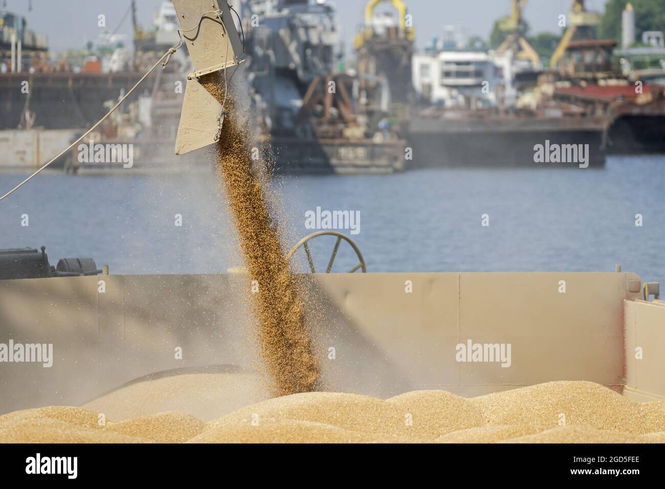Machine pouring sand on a shore Stock Photo - Alamy