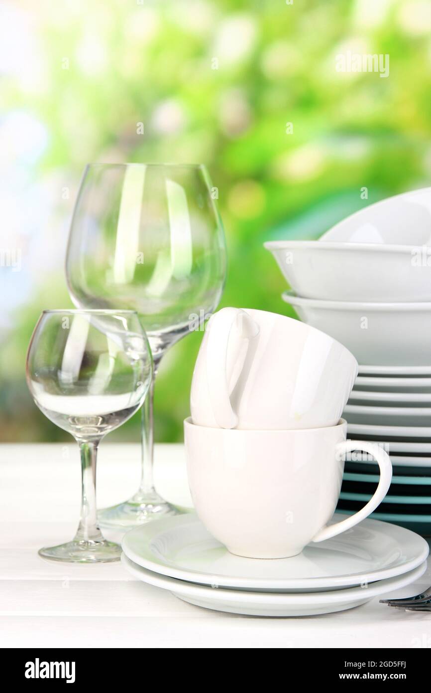 Clean dishes on table on natural background Stock Photo - Alamy