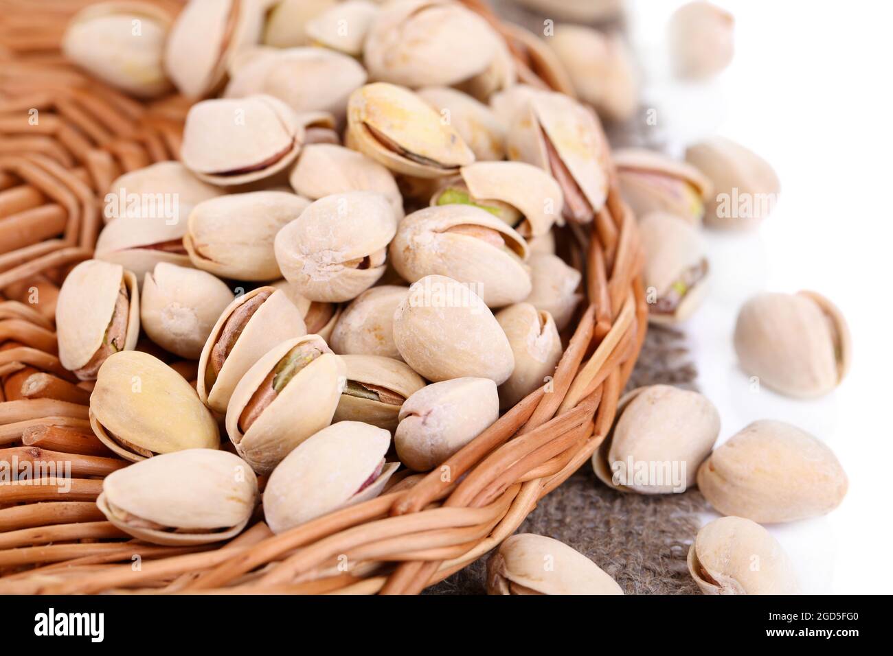 Pistachio nuts on wicker stand with sackcloth close up Stock Photo - Alamy