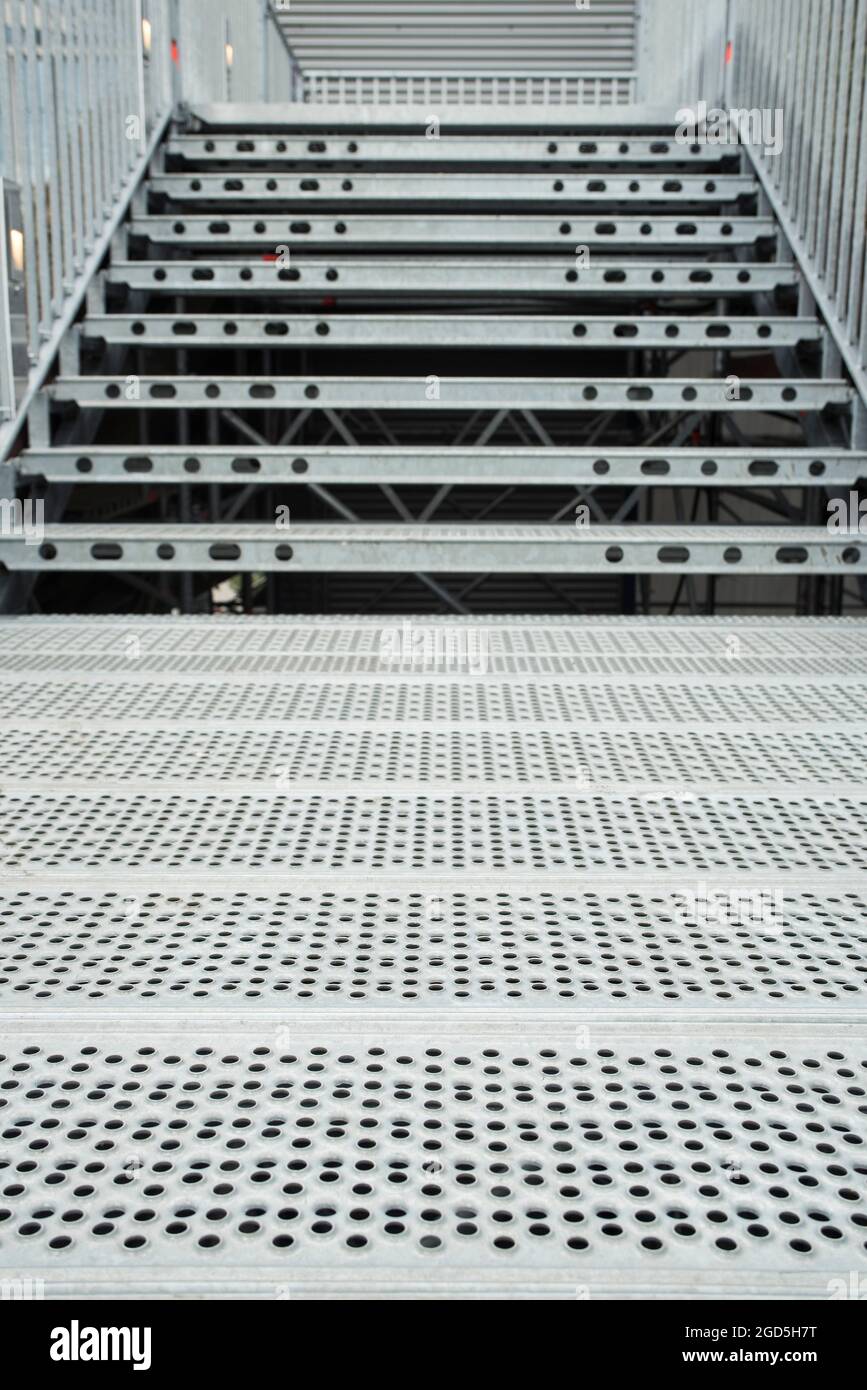 Perforated galvanised steel floor panels and stairs on scaffolding ...