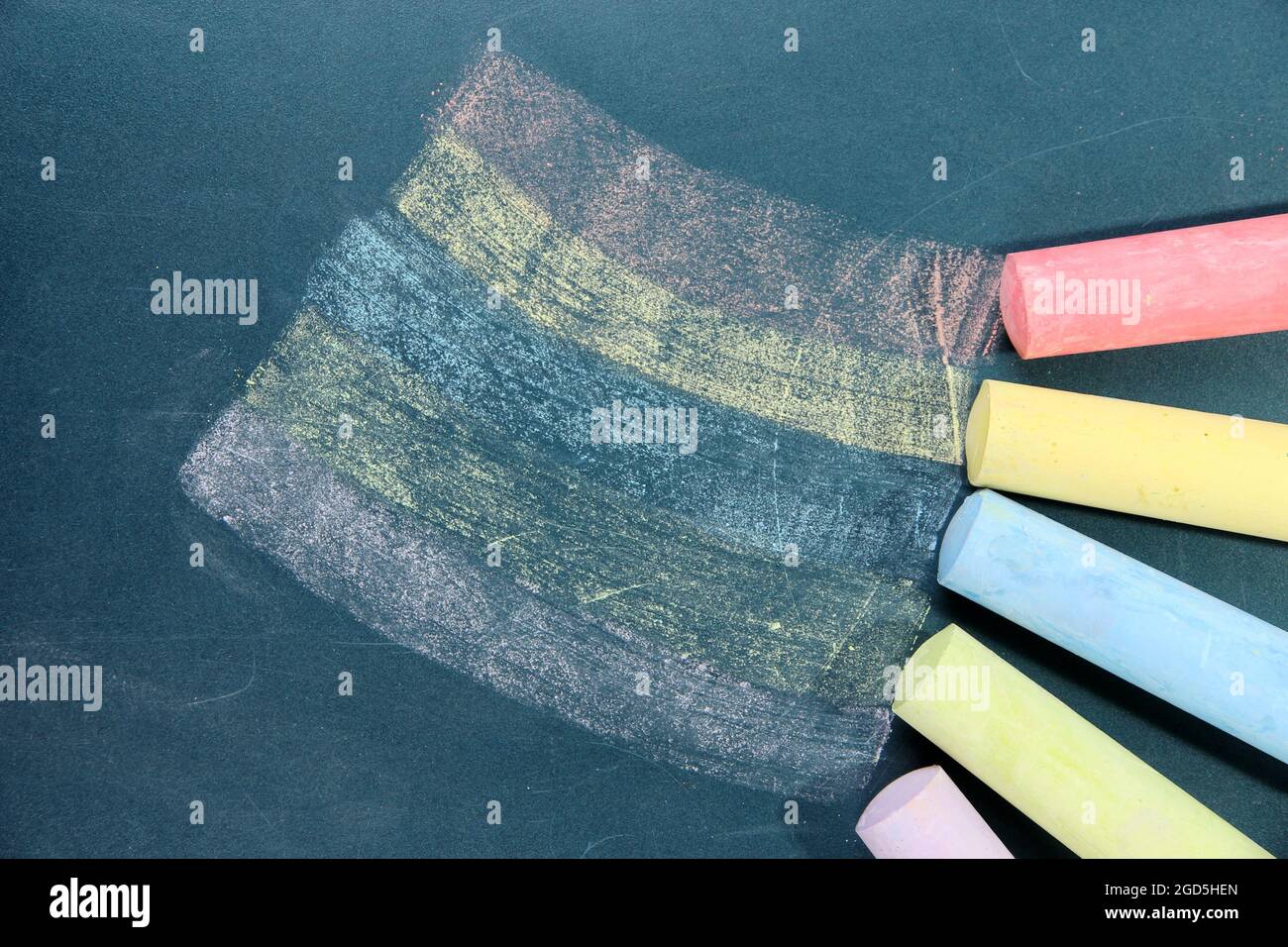 Colorful chalks on school desk Stock Photo - Alamy