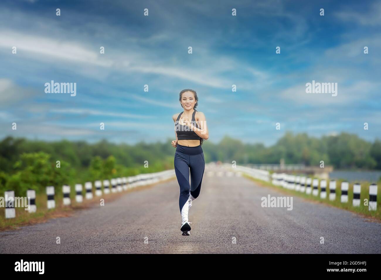 Fitness runner athlete listening to music in headphones from mobile ...