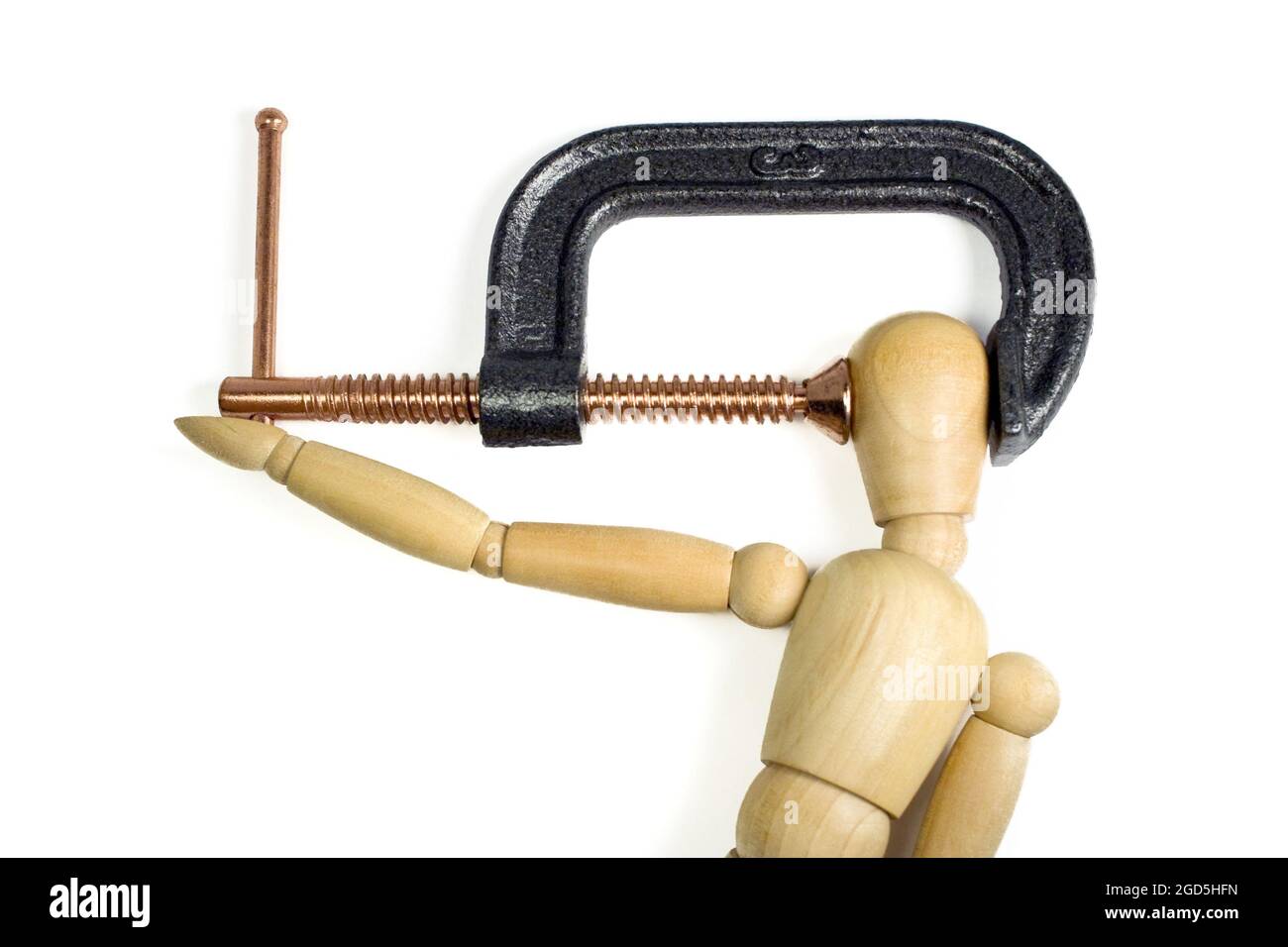 A clamp squeezing tightly on the head of a wooden man. A great concept ...