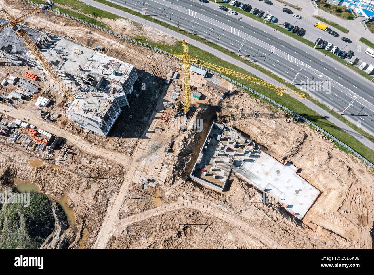 construction site. yellow crane near apartment buildings under ...