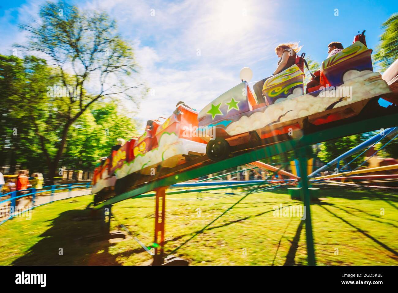 People Having Fun On Rollercoaster In The Park Stock Photo - Alamy