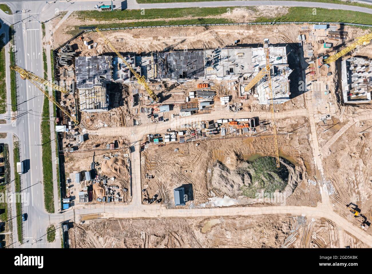 aerial top view of urban construction site with high tower cranes and ...