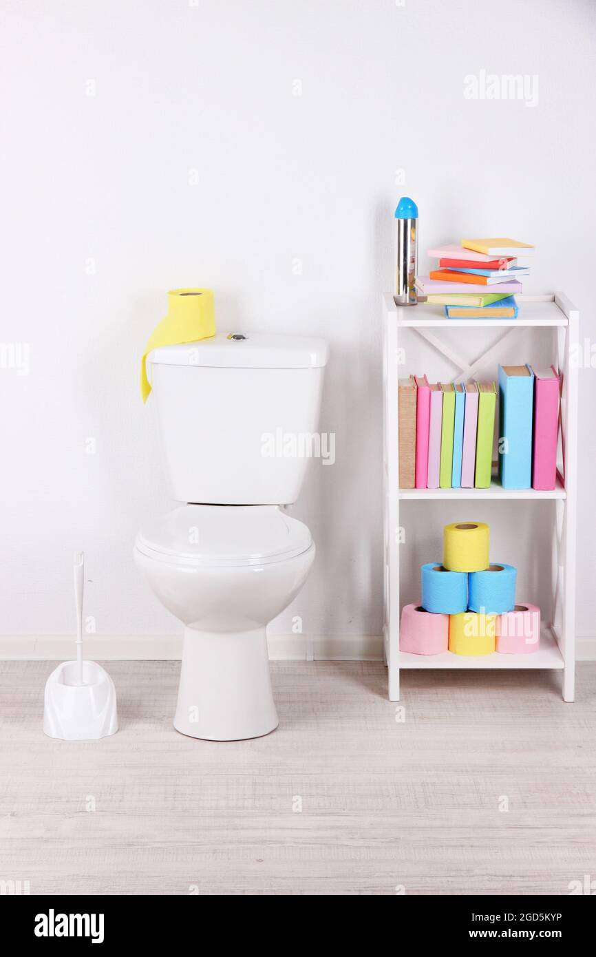 White toilet bowl and stand with books, on color wall background Stock ...