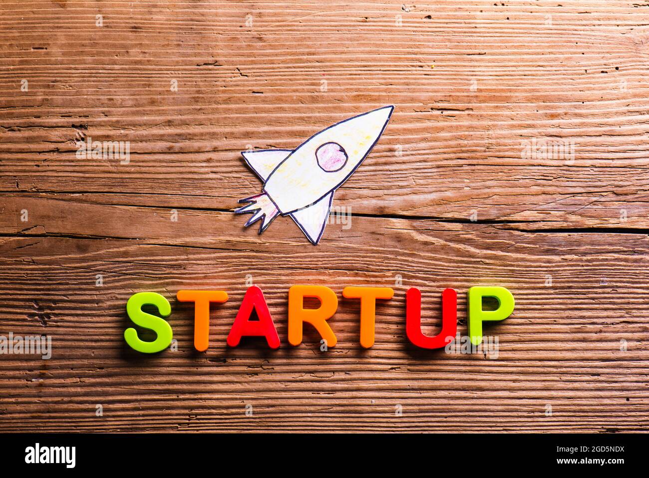 Office desk with start up sign made of colorful plastic letters and ...