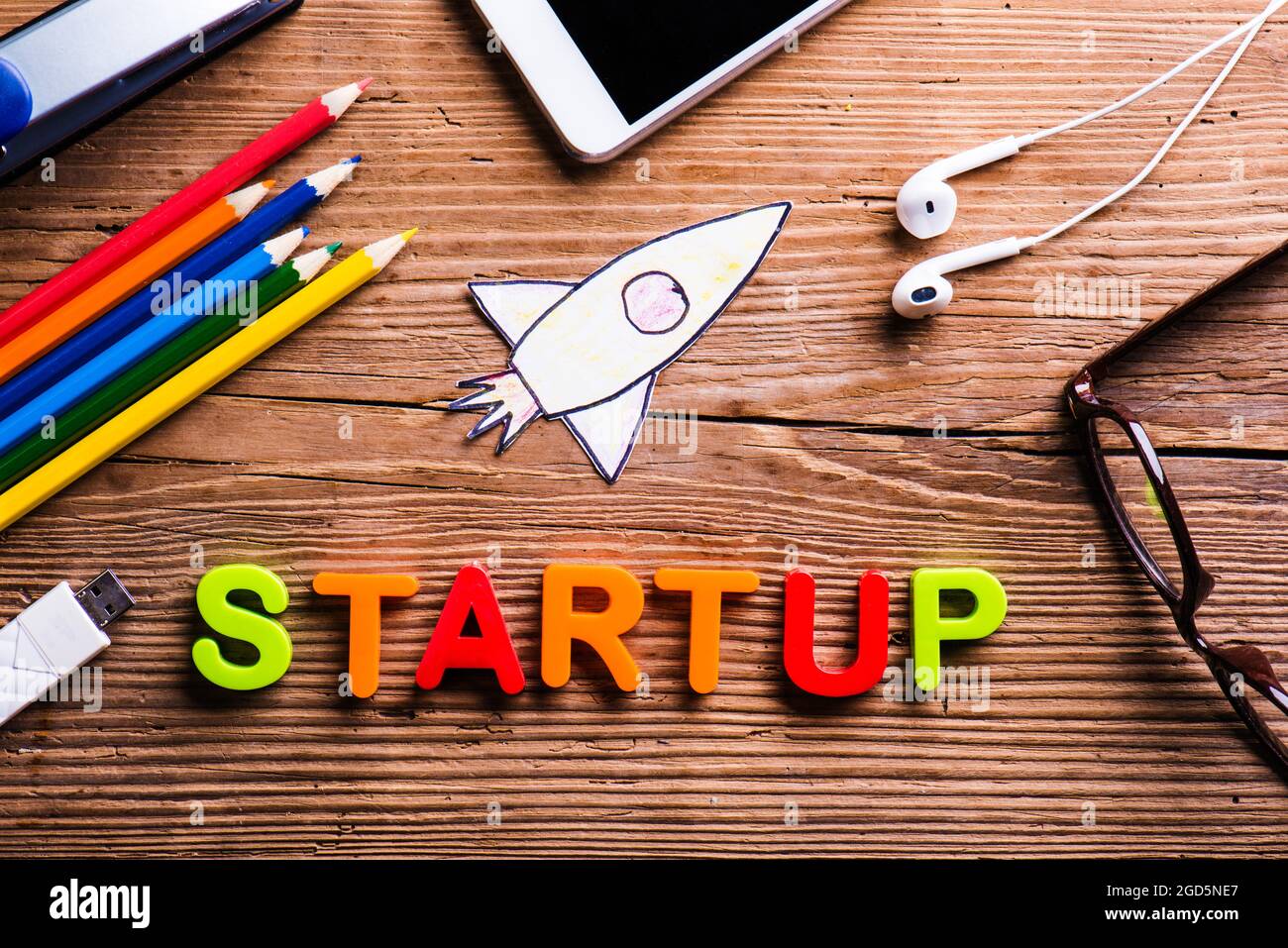 Office desk with start up sign made of colorful plastic letters and ...