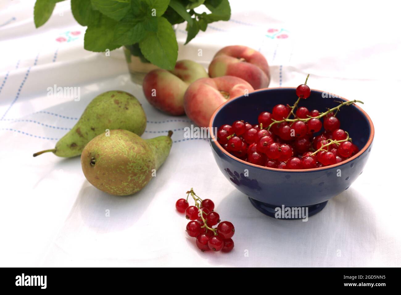Red currant in a blue bowl. Close up photo of seasonal berries. Eating ...