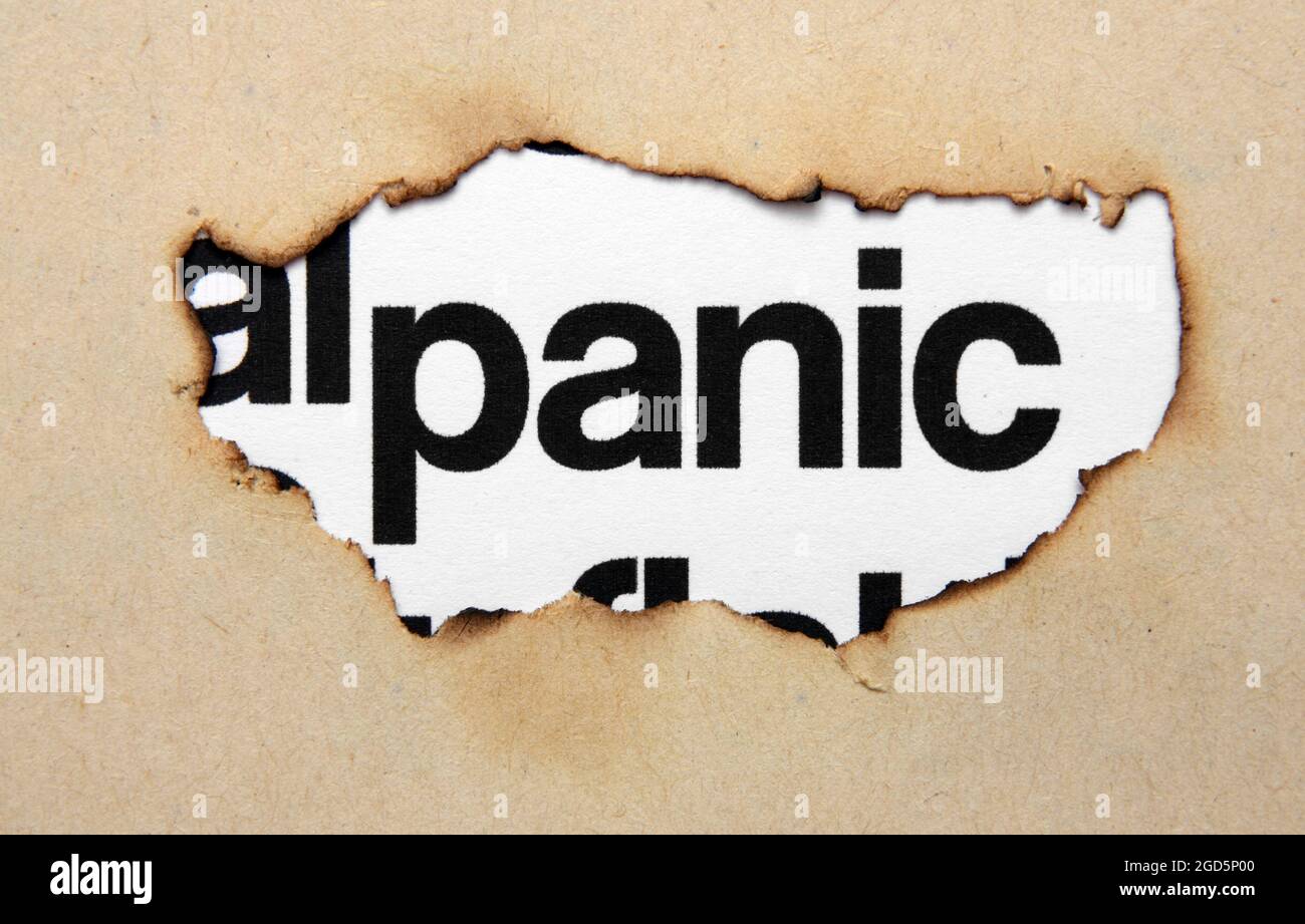 Panic text on paper hole Stock Photo - Alamy
