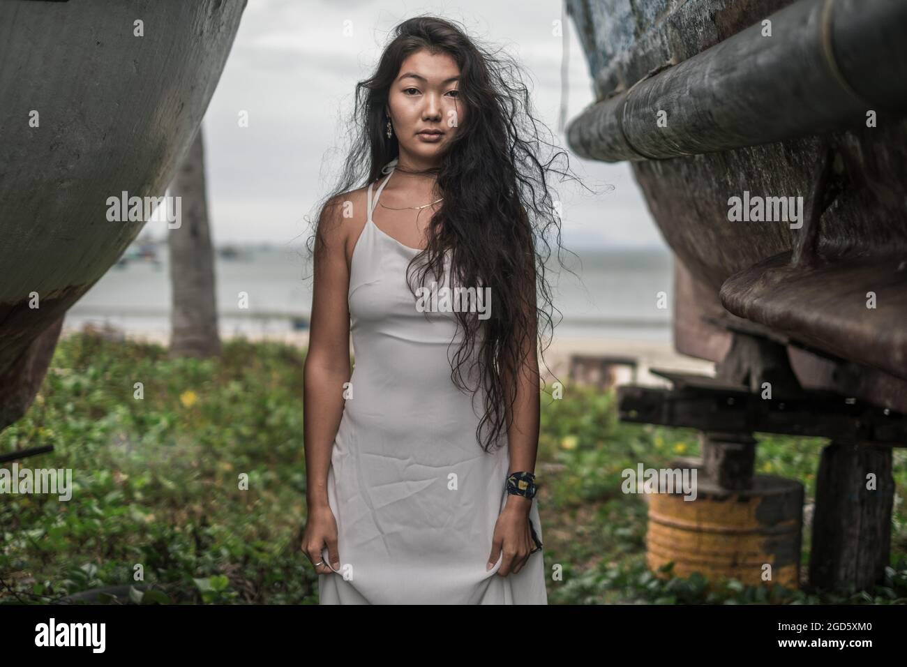 Beautiful young mongol woman in white dress standing between two old ...