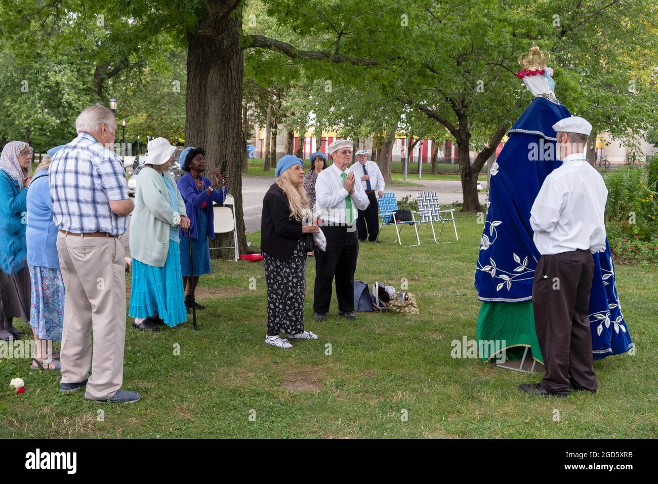 Devout Roman Catholics pray at a service near the Vatican Pavilion site ...