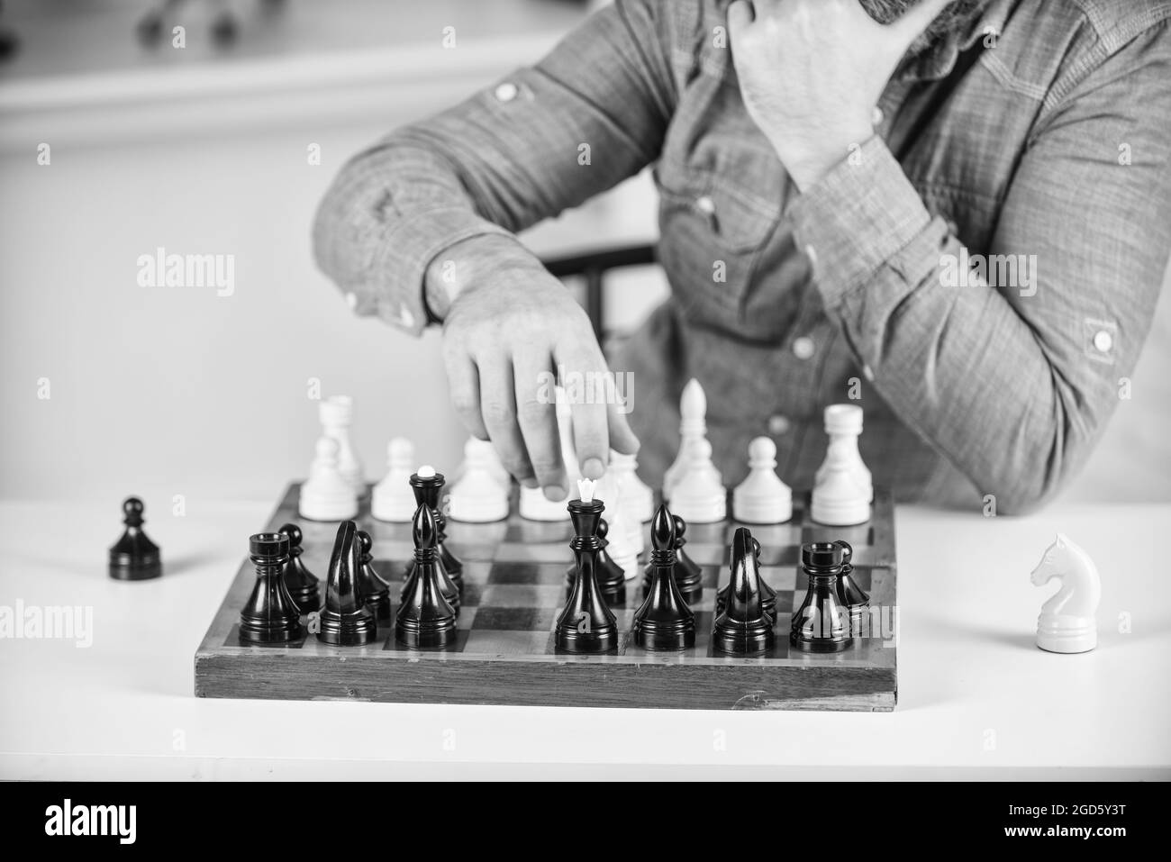 Playing chess. Intellectual hobby. Figures on wooden chess board. Black ...