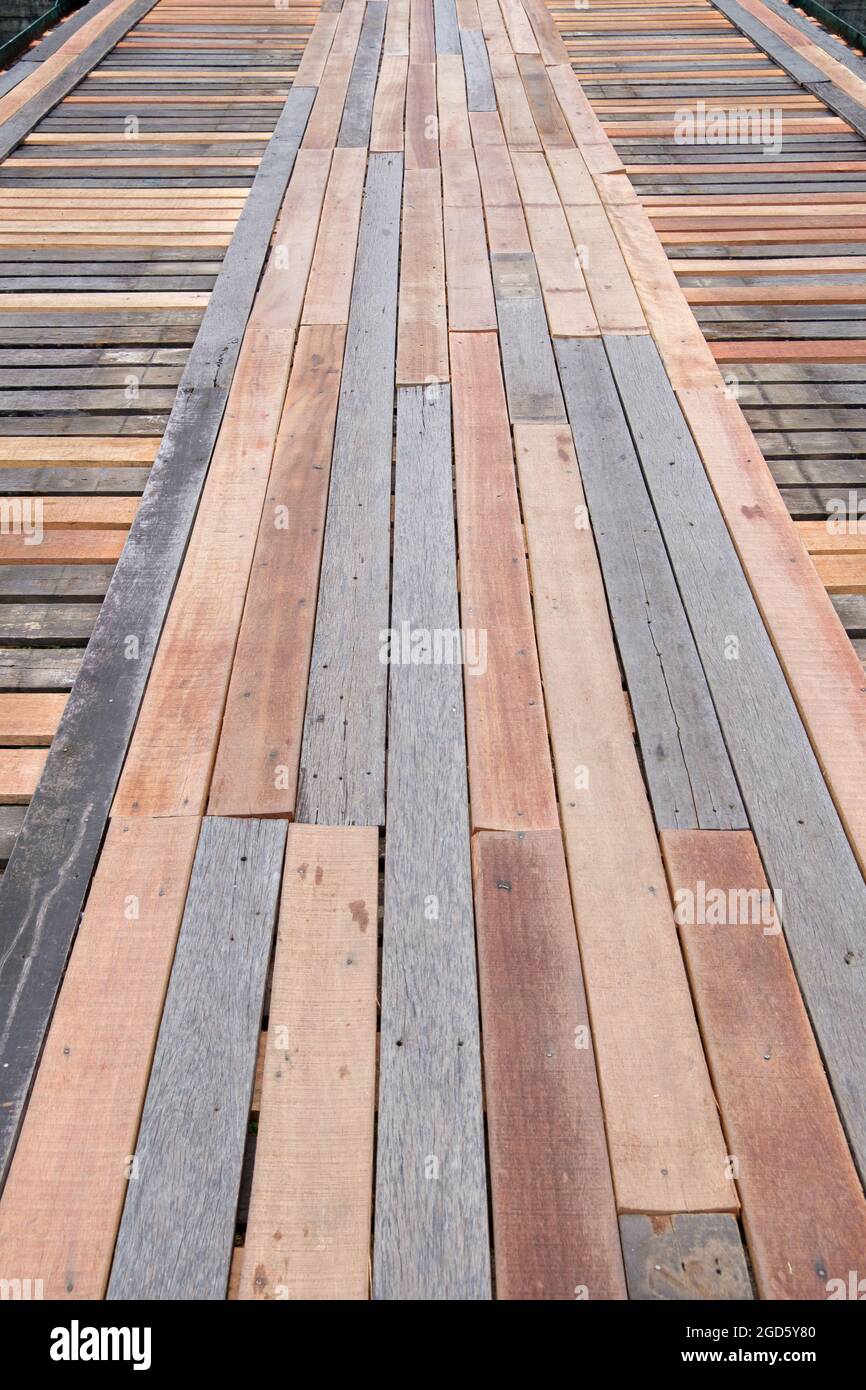 The plank strip board is arranged in a long line to build the walkway ...