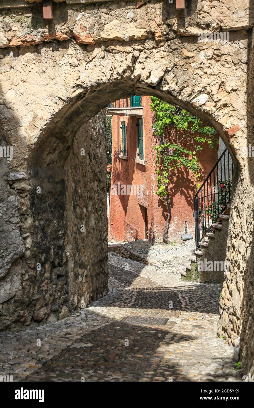 A cobbled, winding street in Malcesine, Italy Stock Photo - Alamy