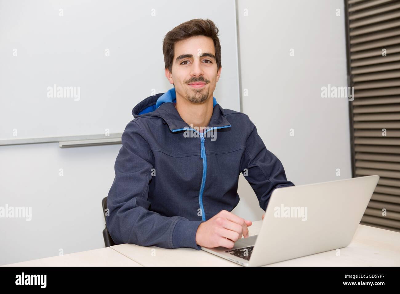 Young student working at computer in classroom Stock Photo - Alamy