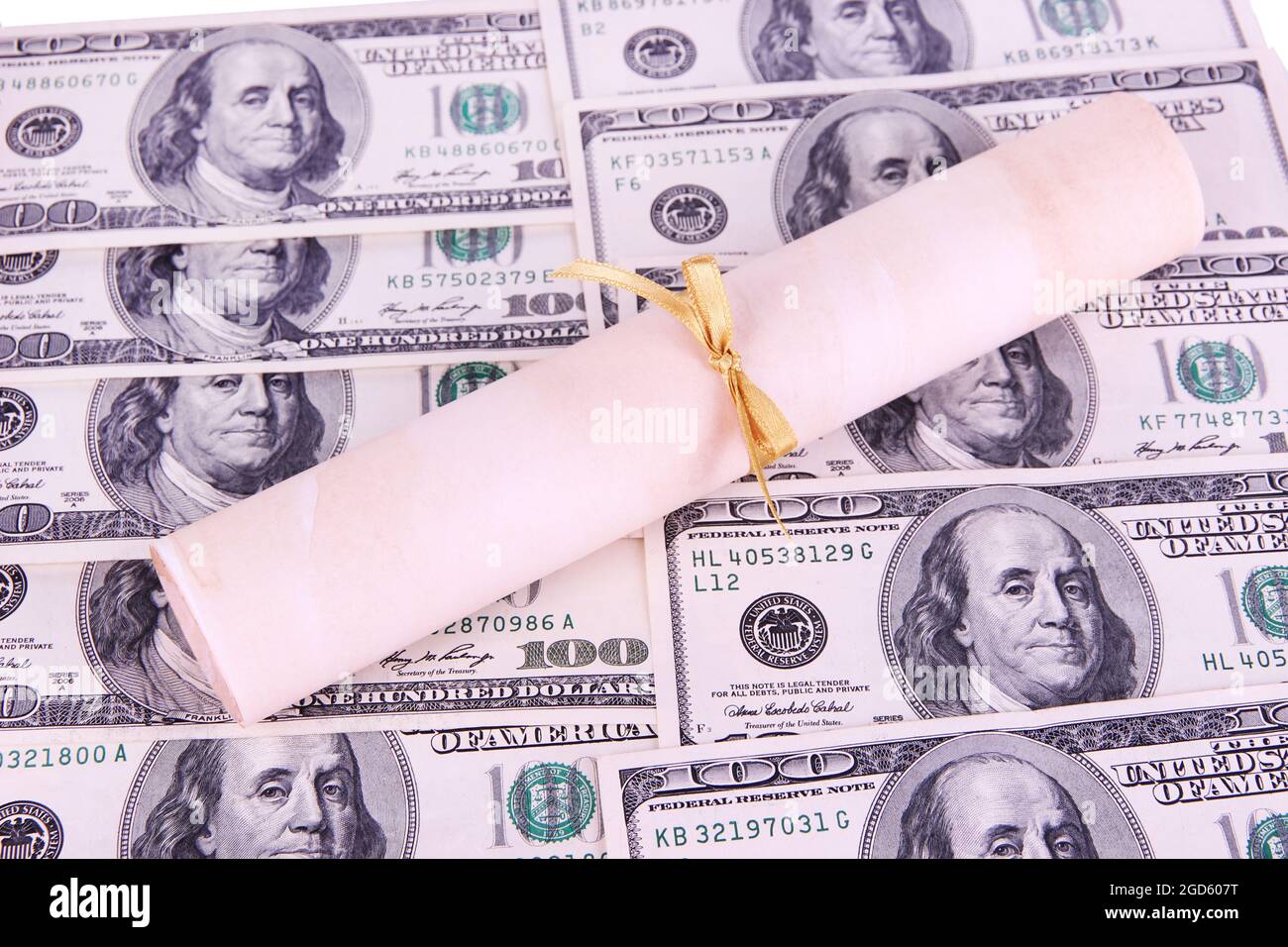 University diploma on dollars background. Cost of education. Conceptual ...