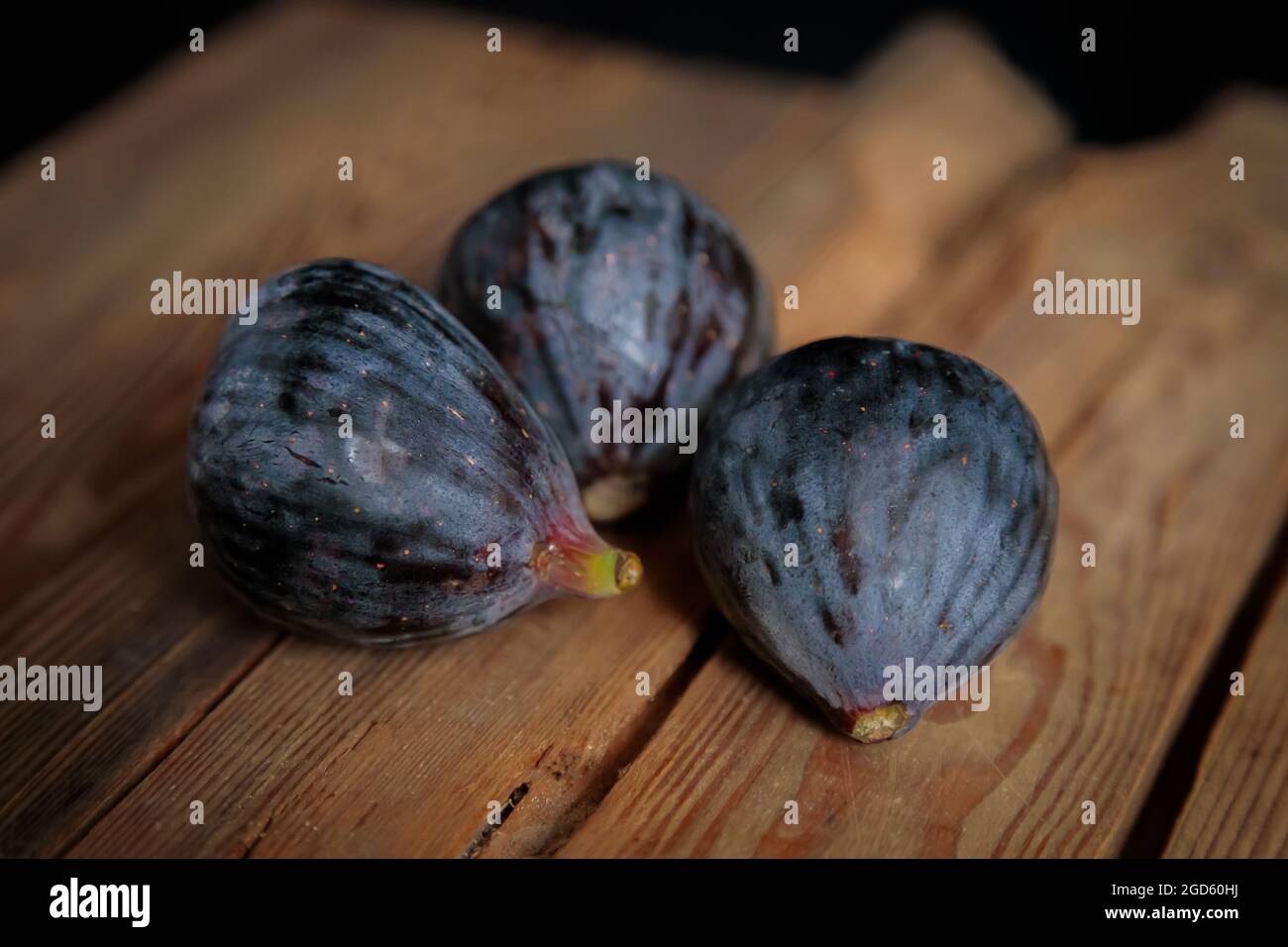 Fresh purple figs on a wooden background from old boards. Raw exotic ...
