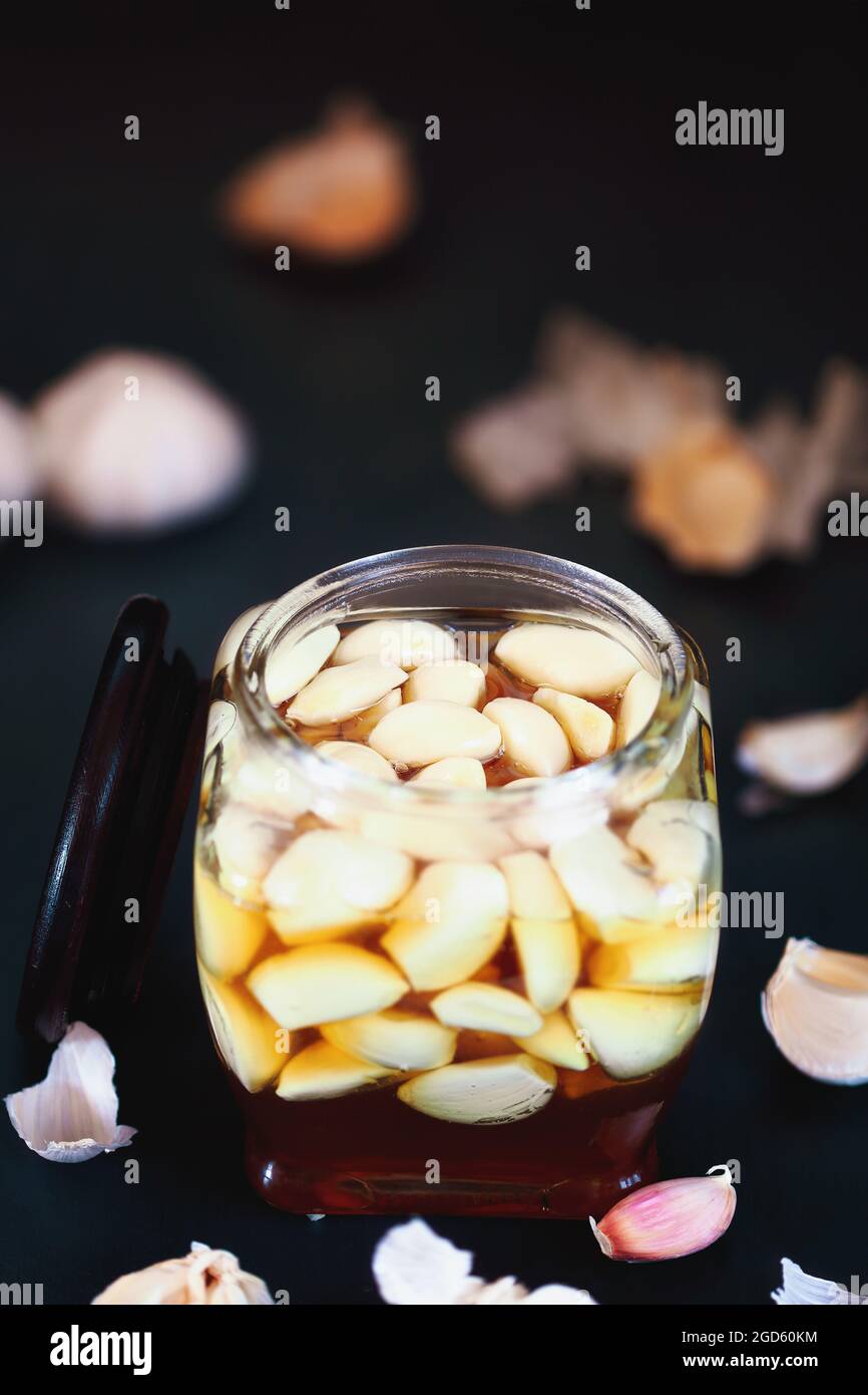 Fermented garlic cloves in a jar of honey, a rich source of probiotics ...