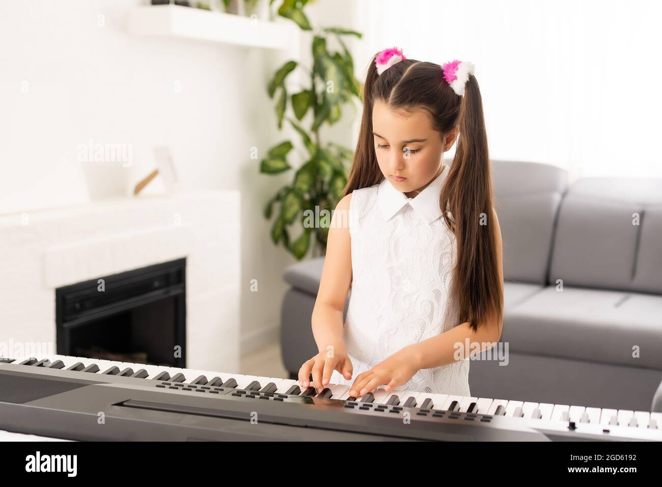 beautiful girl sings while playing on an electronic piano Stock Photo ...