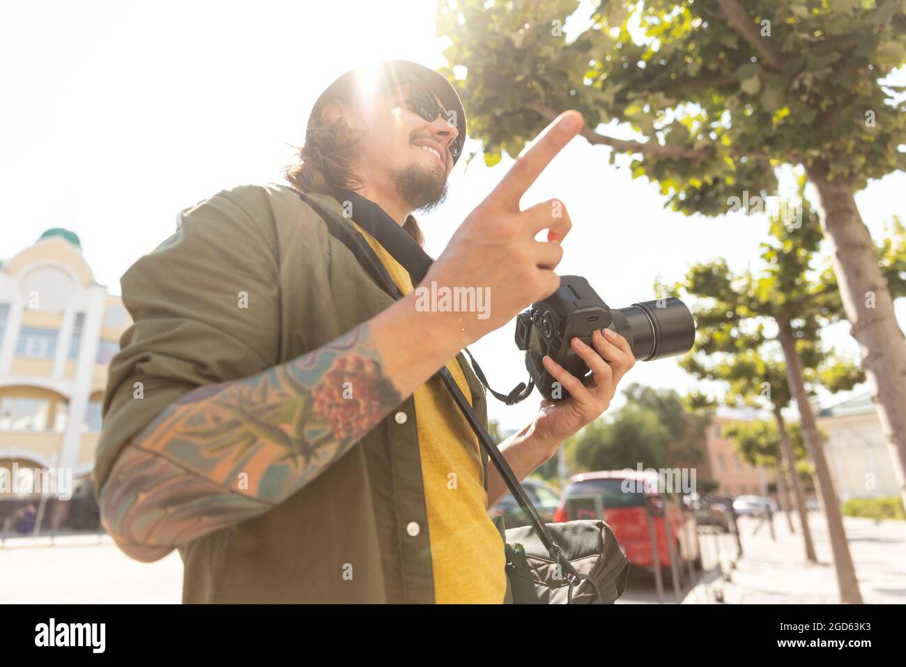 Portrait of young man, photographer, cameraman with professional camera ...