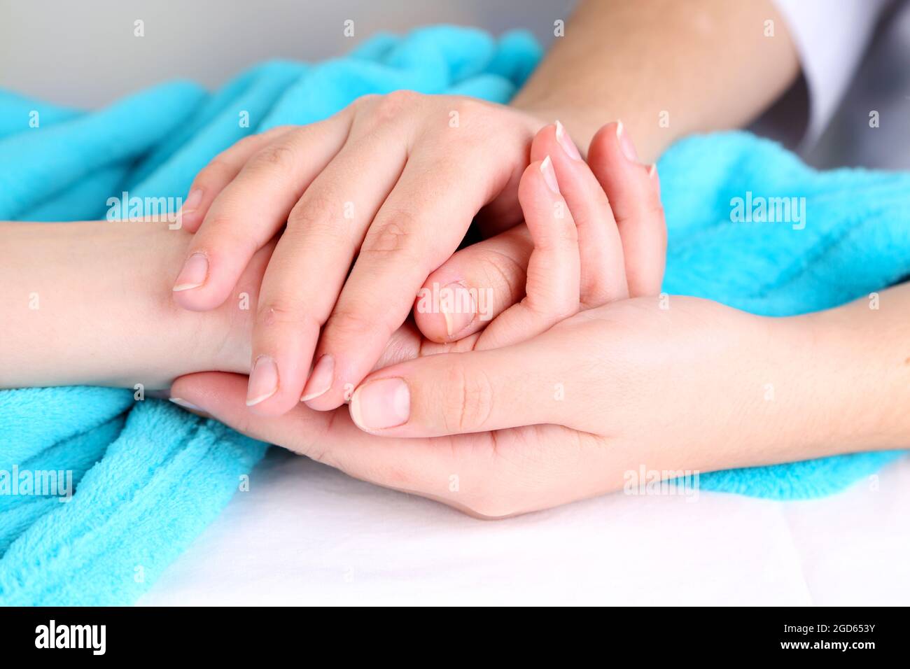 Medical doctor holding hand of patient, on light background Stock Photo ...