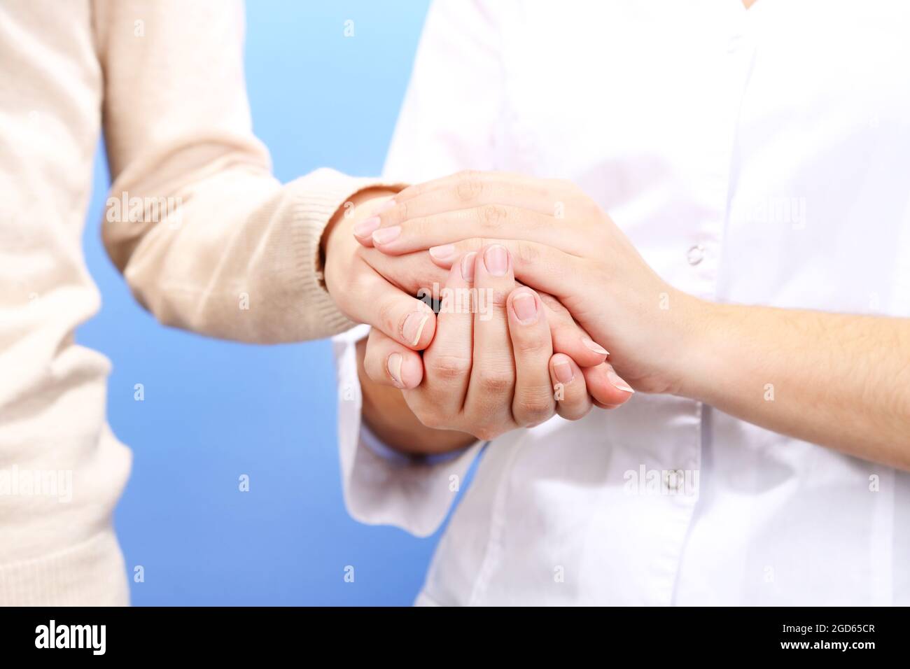 Medical doctor holding hand of patient, on light background Stock Photo ...