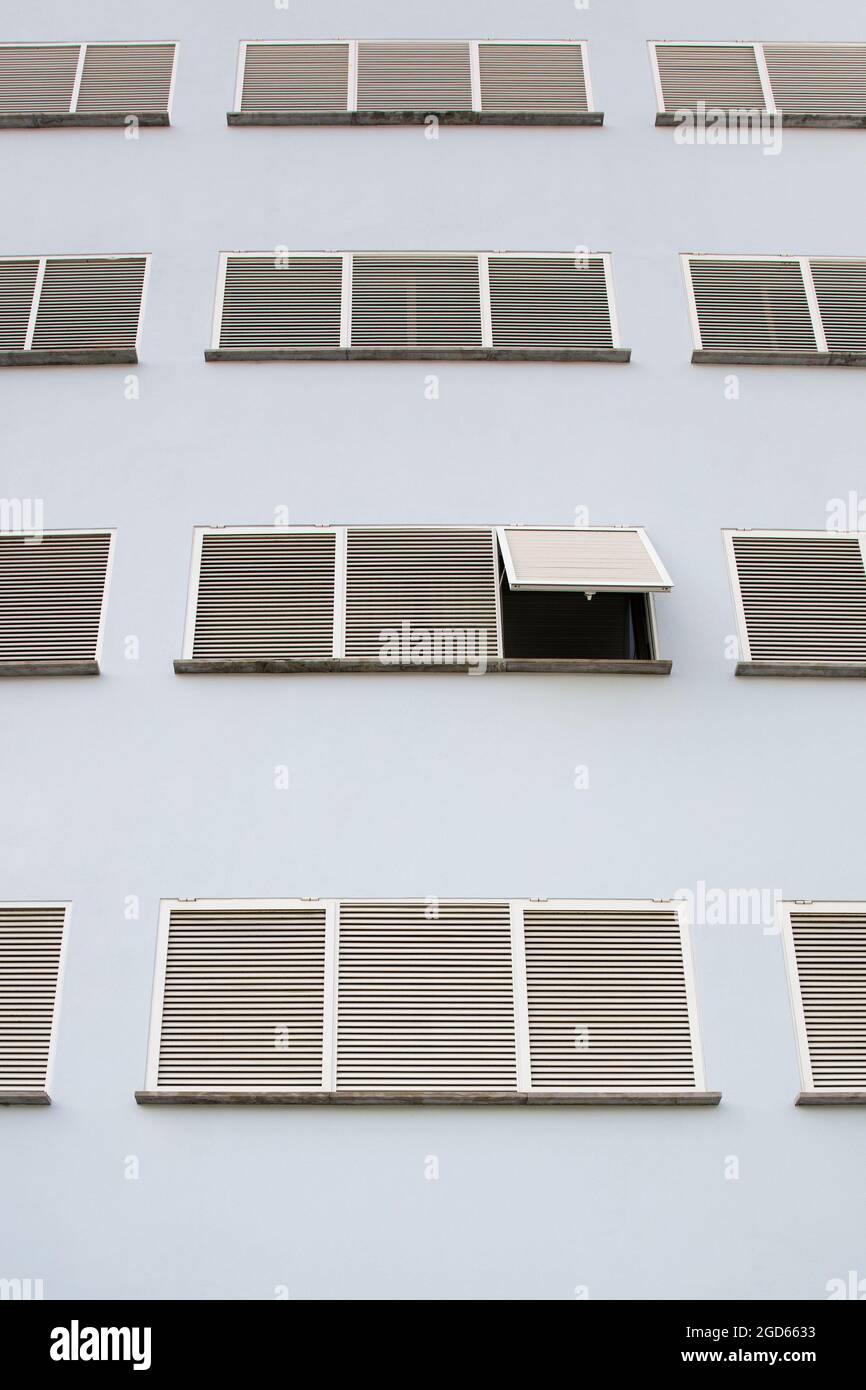 View at building with only one open window shutter Stock Photo - Alamy