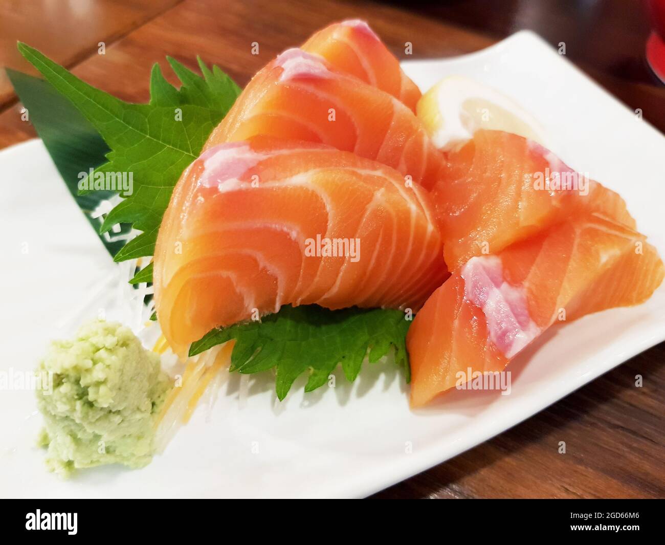 Salmon raw sashimi on brown Japanese traditional dish Stock Photo - Alamy