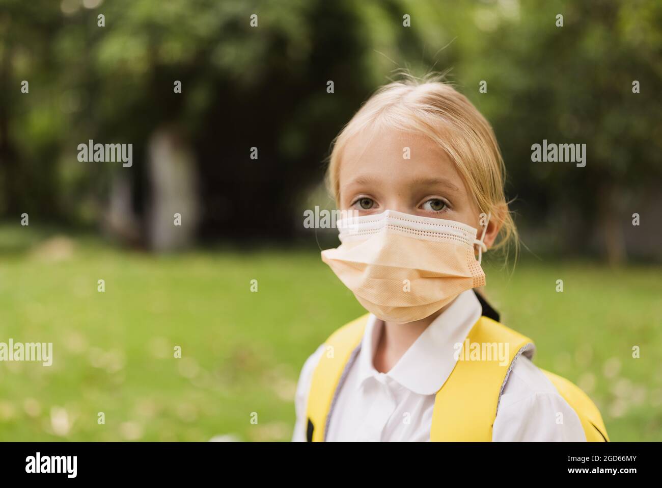 School child wearing protective face mask during coronavirus pandemic ...