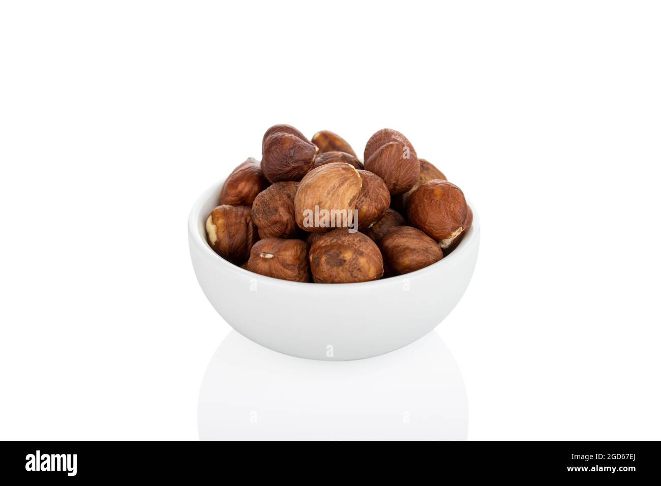 Hazelnut. Shelled hazelnut in white bowl, on white background Stock ...