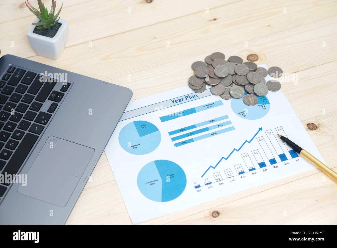 Coins stacks with notebook laptop computer and financial graph Stock ...