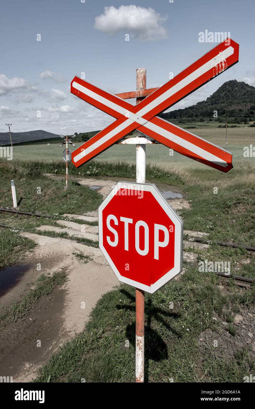 A red STOP sign before crossing the tracks Stock Photo - Alamy