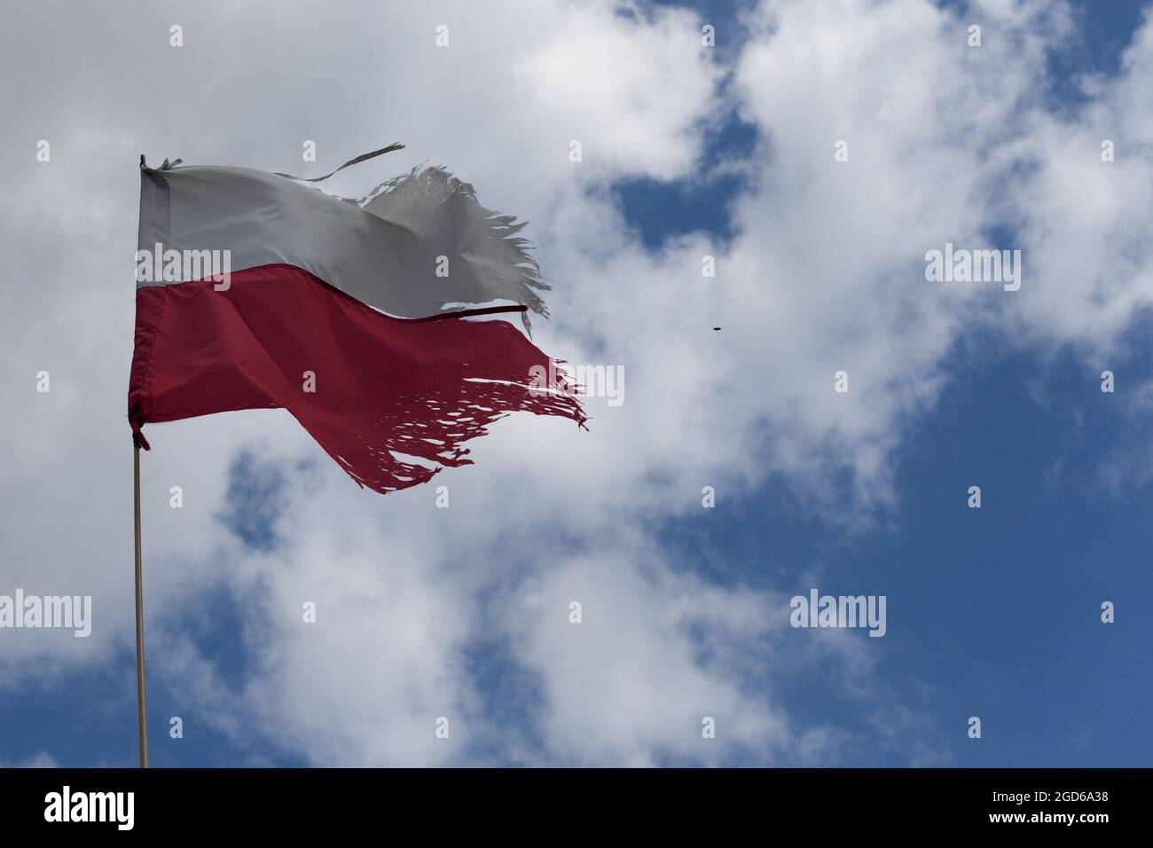 Old Polish flag against the blue sky Stock Photo - Alamy