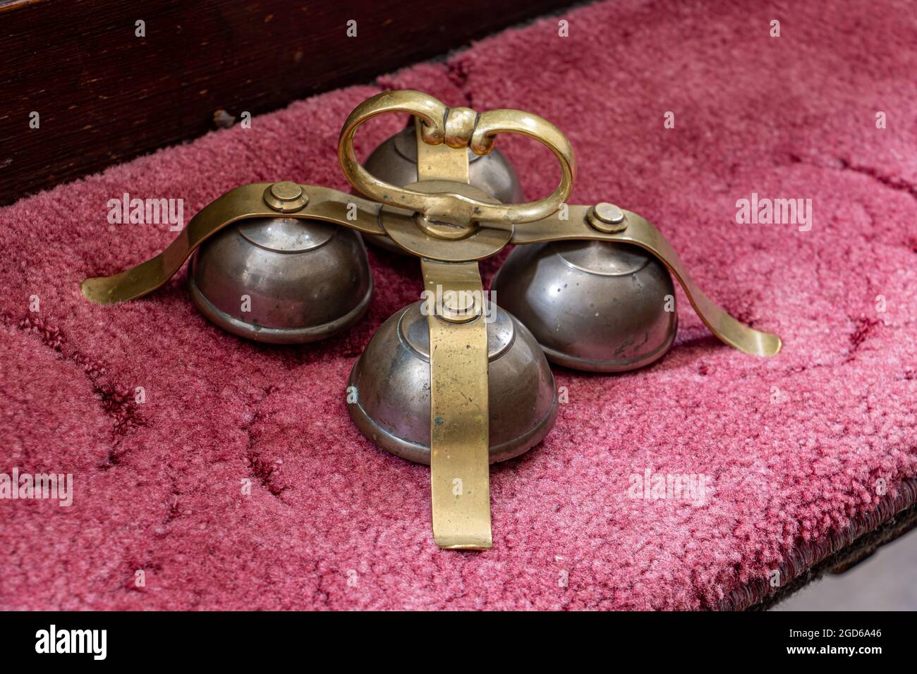 The bells used during Holy Mass lie on the church pew. Equipment for ...