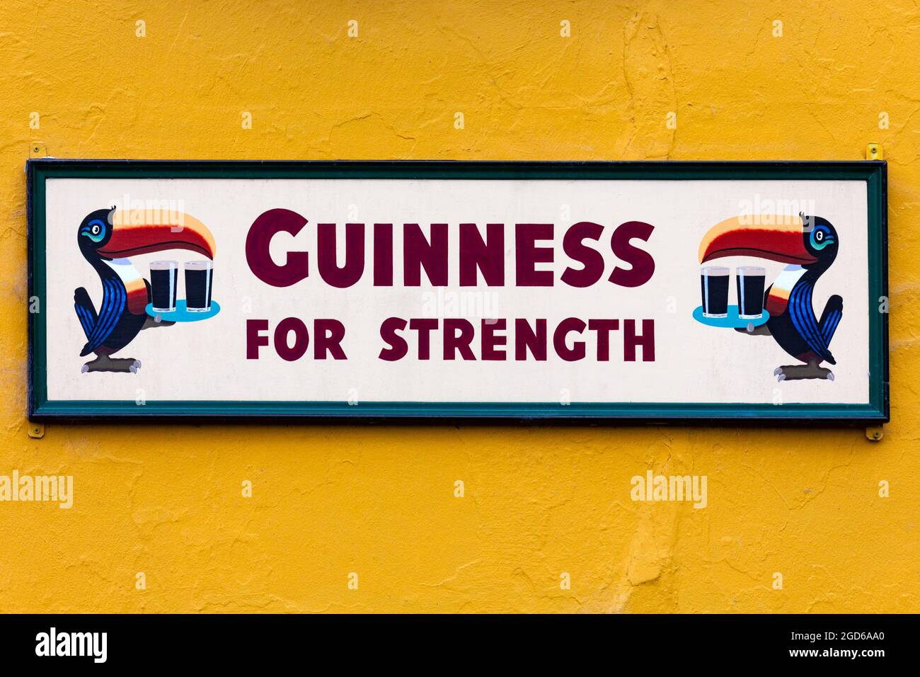 Vintage Guinness advetising sign on a wall outside a pub in Dublin ...