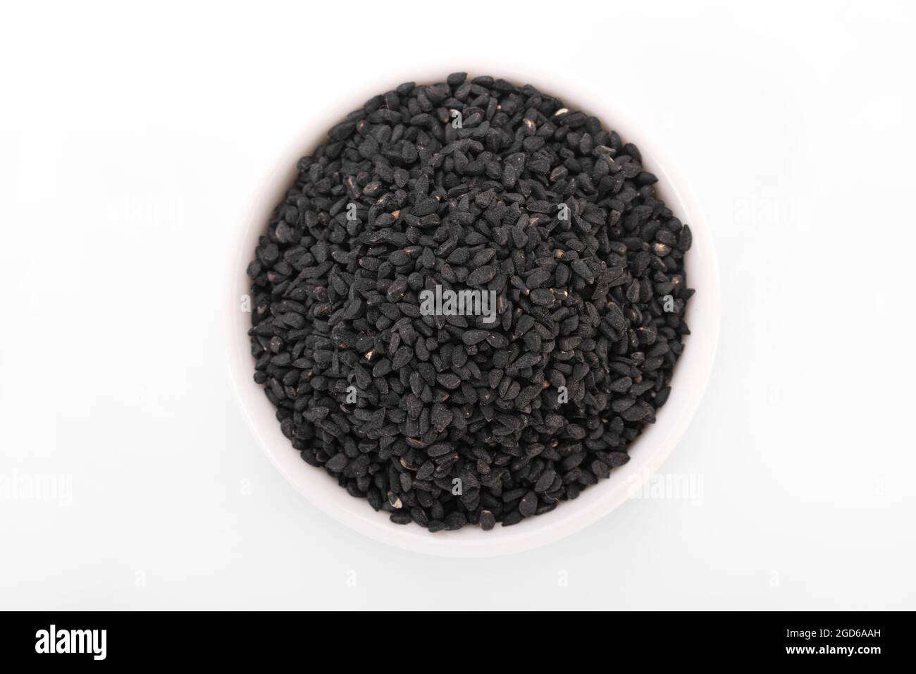 Black cumin seeds. Black cumin in white bowl on white background ...