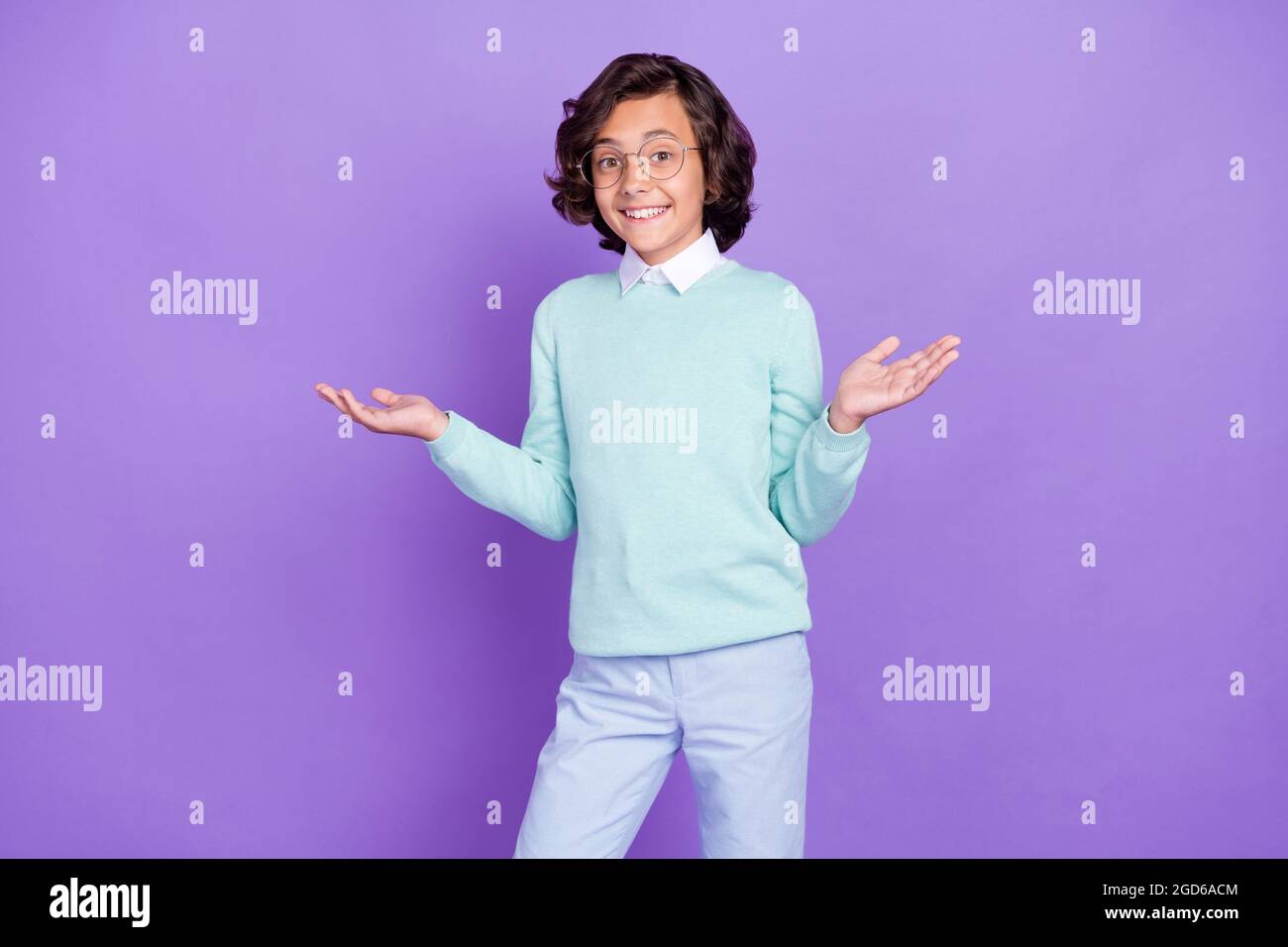 Photo of little cute brunet boy shrug shoulders wear blue sweater ...