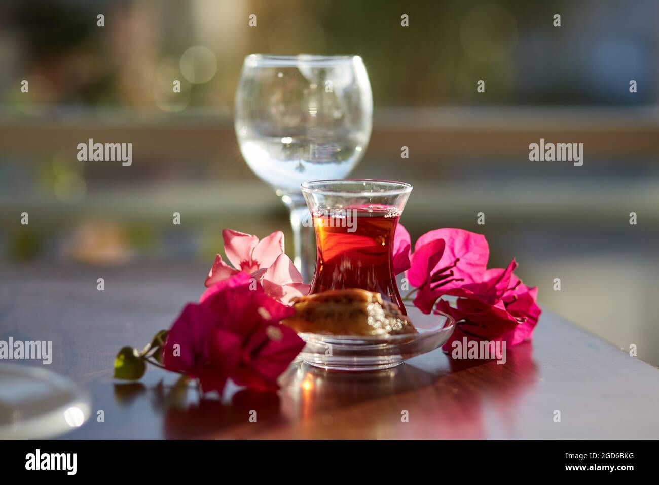 Turkish delight and traditional glass of turkish tea with bougainvillea ...